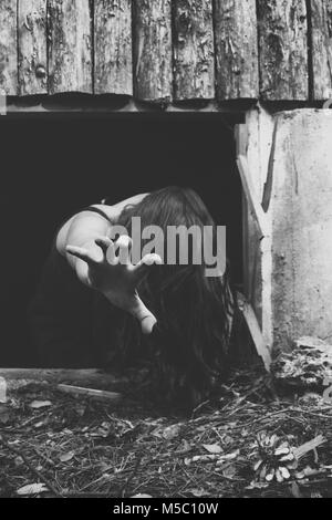 Halloween girl crawl on the ground. Ghost women wear white dress stain ...