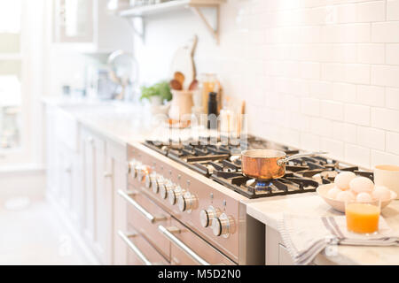 Copper cooking pot on stove in kitchen Stock Photo - Alamy