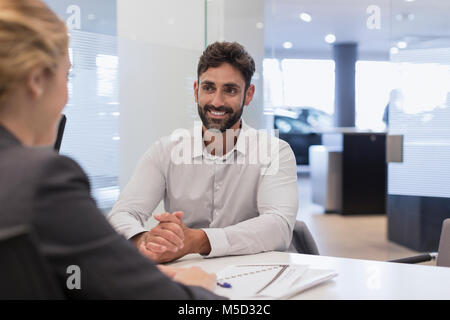 Salesperson discussing with smiling customer sitting in car Stock Photo ...