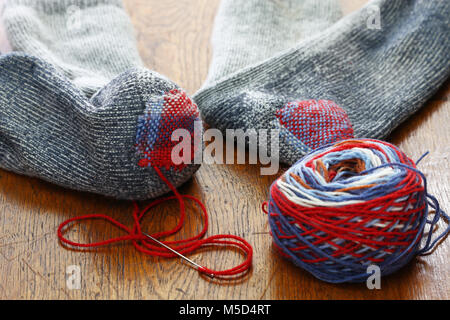 darning socks, repairing holes in socks on white background Stock Photo ...