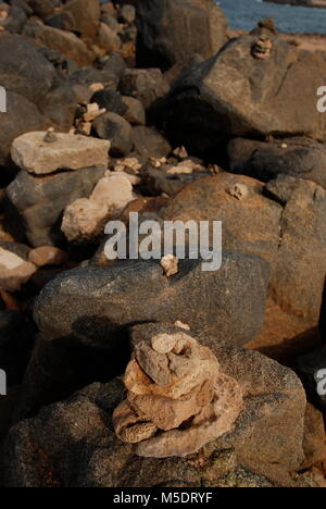 Stacked rocks and shells in Aruba Stock Photo - Alamy