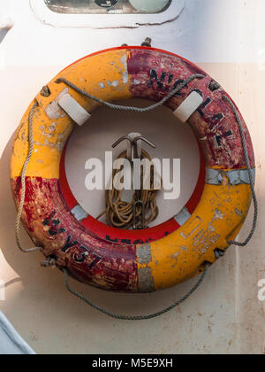 Close-up Yellow life ring hanging on boat with ocean background Stock ...