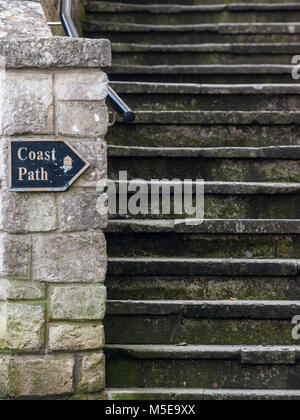 A coastal path sign pointing towards the beach on a stormy day Stock ...