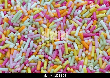 Hundreds and thousands multicolored sugar strands and white and red ...