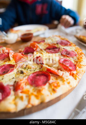 Pizza on desk - focus selected, natural light Stock Photo - Alamy