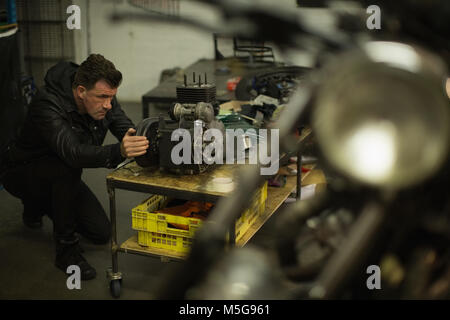 Mechanic repairing a motorcycle engine Stock Photo - Alamy