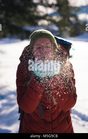 woman blowing snow in hands in slow motion Stock Photo - Alamy