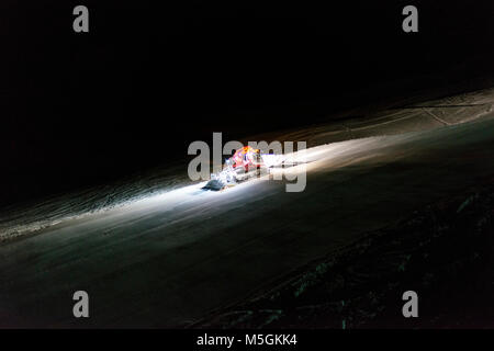 An amazing view of a snowcat in the snow at the top of a ski piste in ...