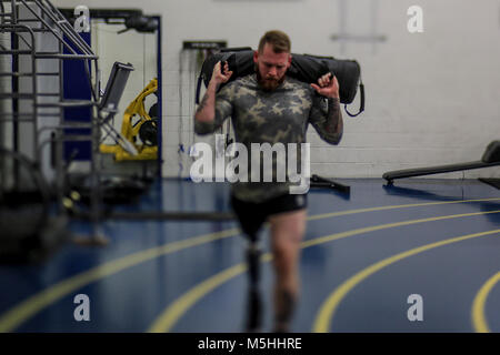 Cpl. Rory Hamill, a combat-wounded Marine, works out in the base gym on ...