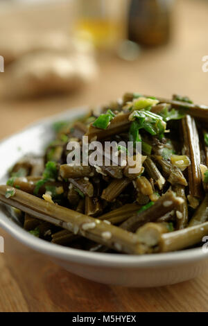 Sauteed bracken fern salad with sesame oil and seeds Stock Photo - Alamy