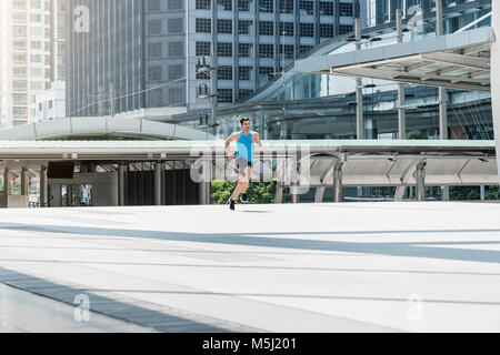 Running man jogging in city park at beautiful summer day. Sport fitness ...