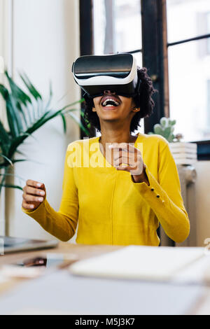 Afro woman wearing a virtual reality glasses in a garden Stock Photo ...
