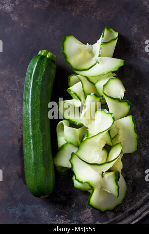 Bright courgette close up. Dark black wooden table background Stock ...