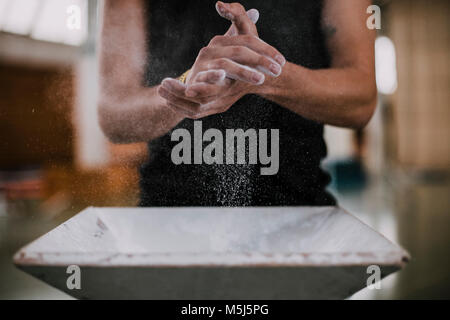 Fit man applying chalk on his hands Stock Photo - Alamy