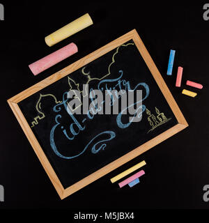 Eid al Fitr greeting written with colorful chalk Stock Photo - Alamy