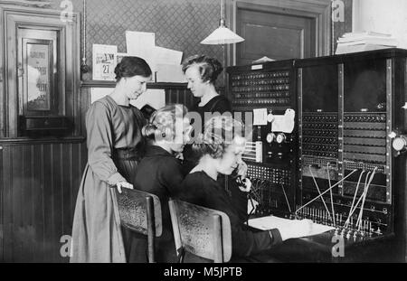 Female telephone operators at work in a telephone exchange room, c ...