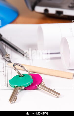 Home keys, electrical drawings or diagrams, protective helmet and small ...
