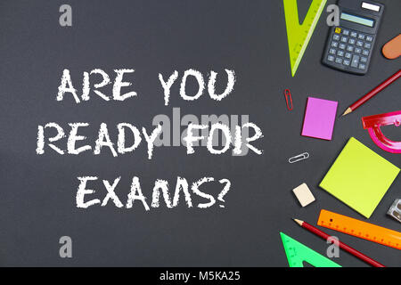 Stationery with chalkboard with text ARE YOU READY FOR EXAM? on wooden ...