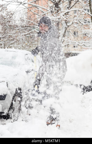 Man shoveling snow in winter Stock Photo - Alamy