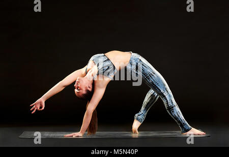 Fit supple woman arching over her back Stock Photo - Alamy