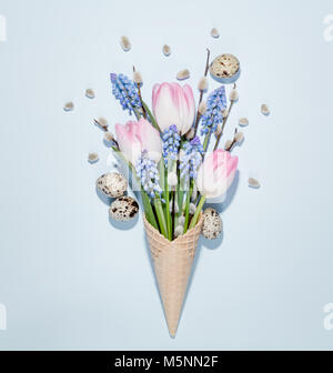 Bouquet Flowers in a waffle cone on a black background. Flat lay, top ...
