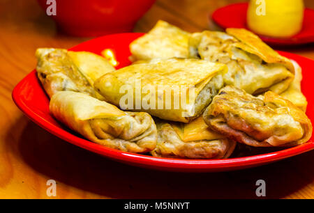 Thin rolled pancakes stuffed with mushrooms, pan-fried Stock Photo - Alamy