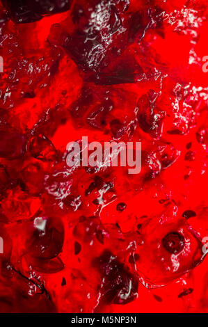 Bright translucent red currant jam in a glass jar, close-up, macro ...