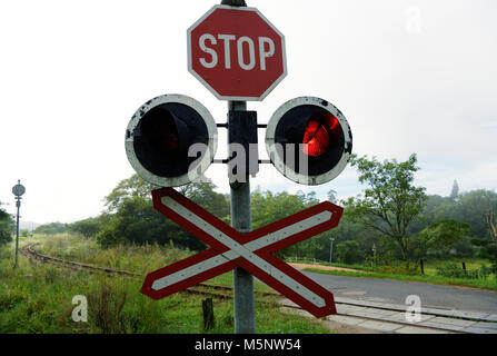 Railway tracks red flashing warning light sign level crossing barrier ...