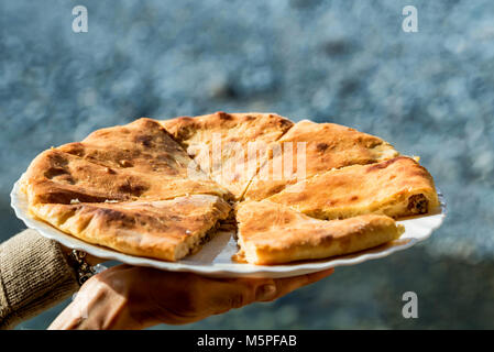 Caucasian khychin bread pie with meat close Stock Photo - Alamy