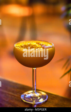 Freshly squeezed mango juice with ice in glass with a straw, ripe cut ...