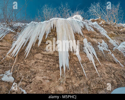 Huge blocks of ice hanging from the cliff. The beauty of the wild Stock ...