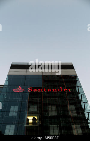 A person in an illuminated lift in the Santander building in London ...