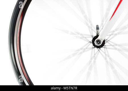 The front wheel of the bicycle rotates quickly on a white background ...