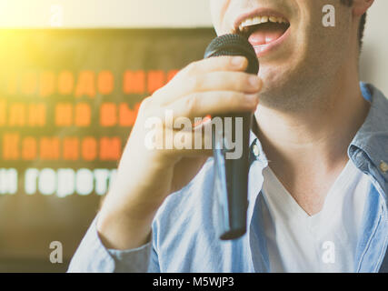 Man singing karaoke at home. Close-up view Stock Photo - Alamy