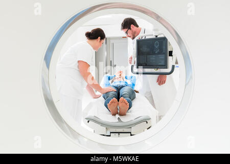 Doctor or nurse and patient with tomography CT or MRI Scan in hospital ...
