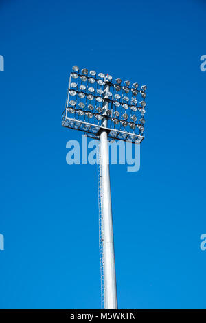 Outdoor stadium flood lights and stand against a white sky background ...