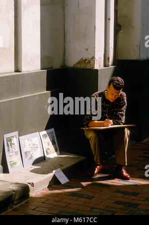 The young male artist drawing pictures in bright studio Stock Photo - Alamy