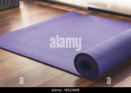 Unrolled yoga mat in empty fitness studio Stock Photo - Alamy