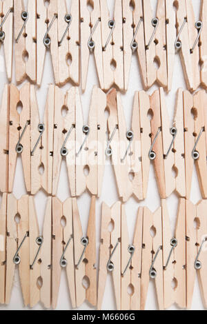 Aligned clothing pegs isolated on a white background Stock Photo - Alamy