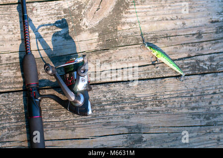 Fishing tackle - fishing spinning, hooks and lures on wooden background ...