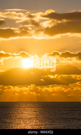 Clouds over sea at sunset Stock Photo - Alamy