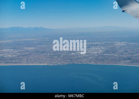 Airplane view of Los Angeles with ocean and plane wing city landscape ...