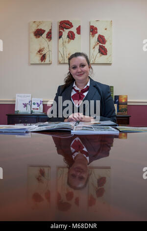 a female member of staff at an undertakers helps to plan a funeral with ...