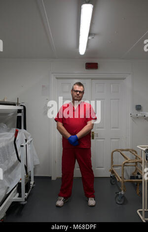 a male embalmer poses for a portrait behind the scenes in an ...