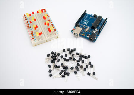 Arduino, wires and around transistors lined up on a white background ...