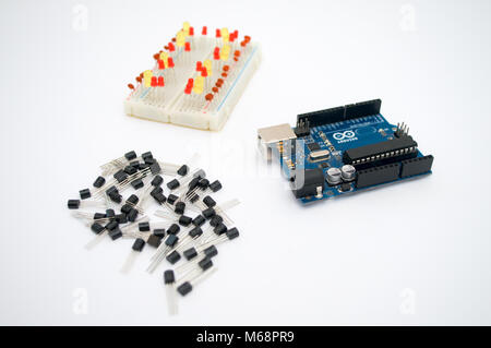 Arduino, wires and around transistors lined up on a white background ...