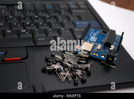 Arduino, wires and around transistors lined up on a white background ...
