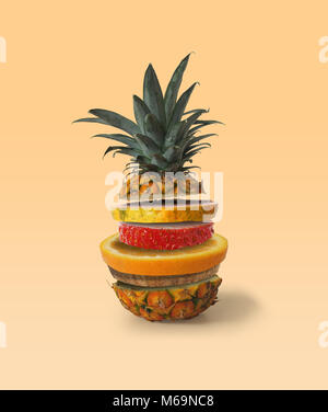 A single ripe papaya with yellow, orange, and green skin on a textured ...