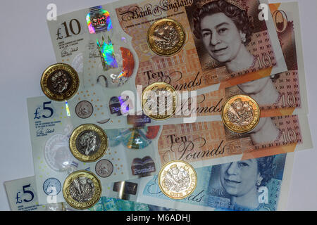 Pound coins and banknotes money (GBP), currency of United Kingdom, over ...