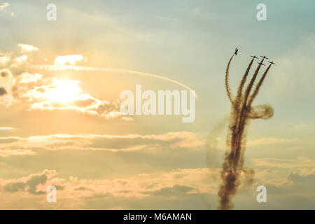Acrobatic planes doing acrobatics at an Airshow flying at sunset / dusk ...